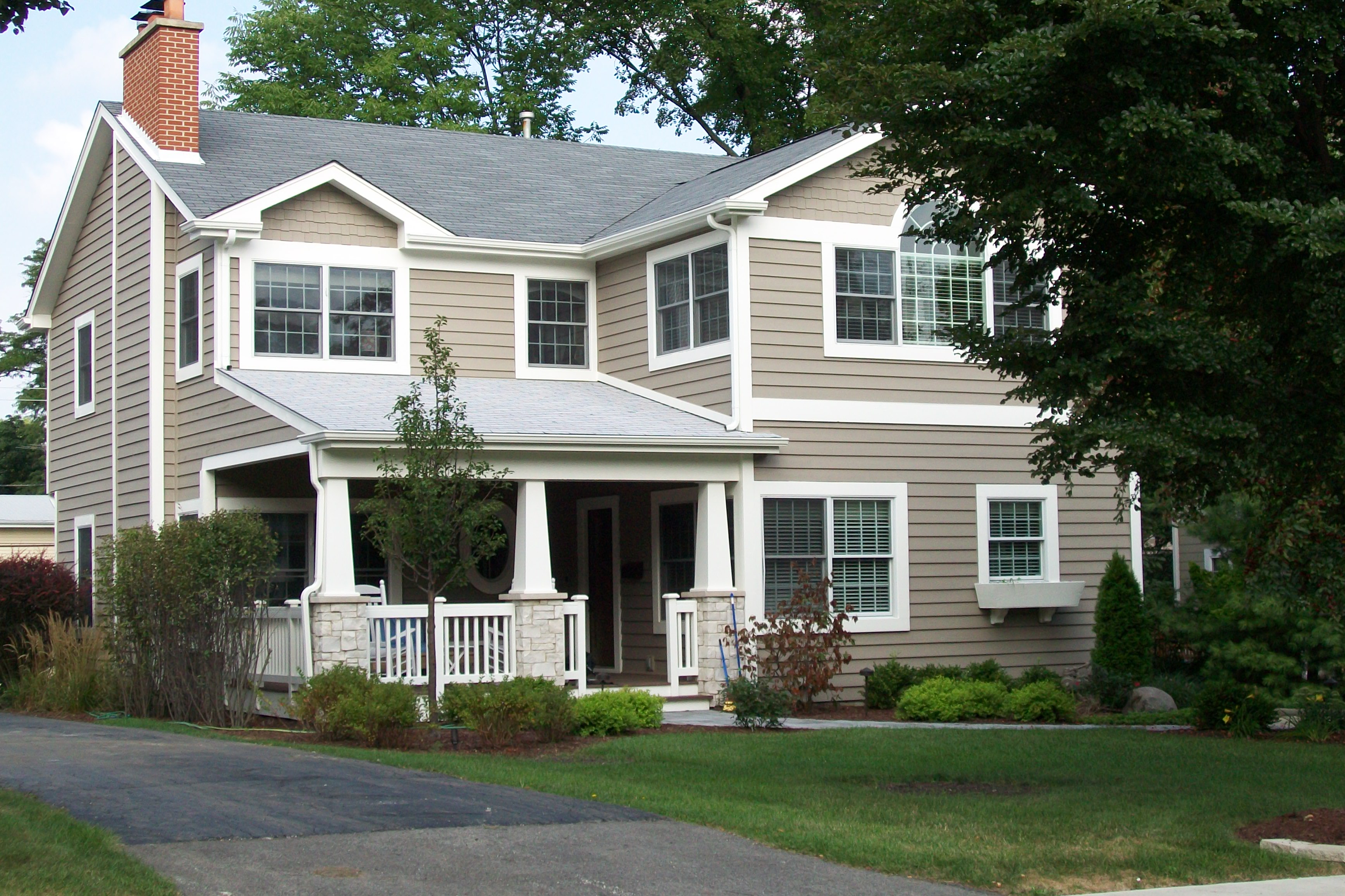 Tan house with porch and white trim